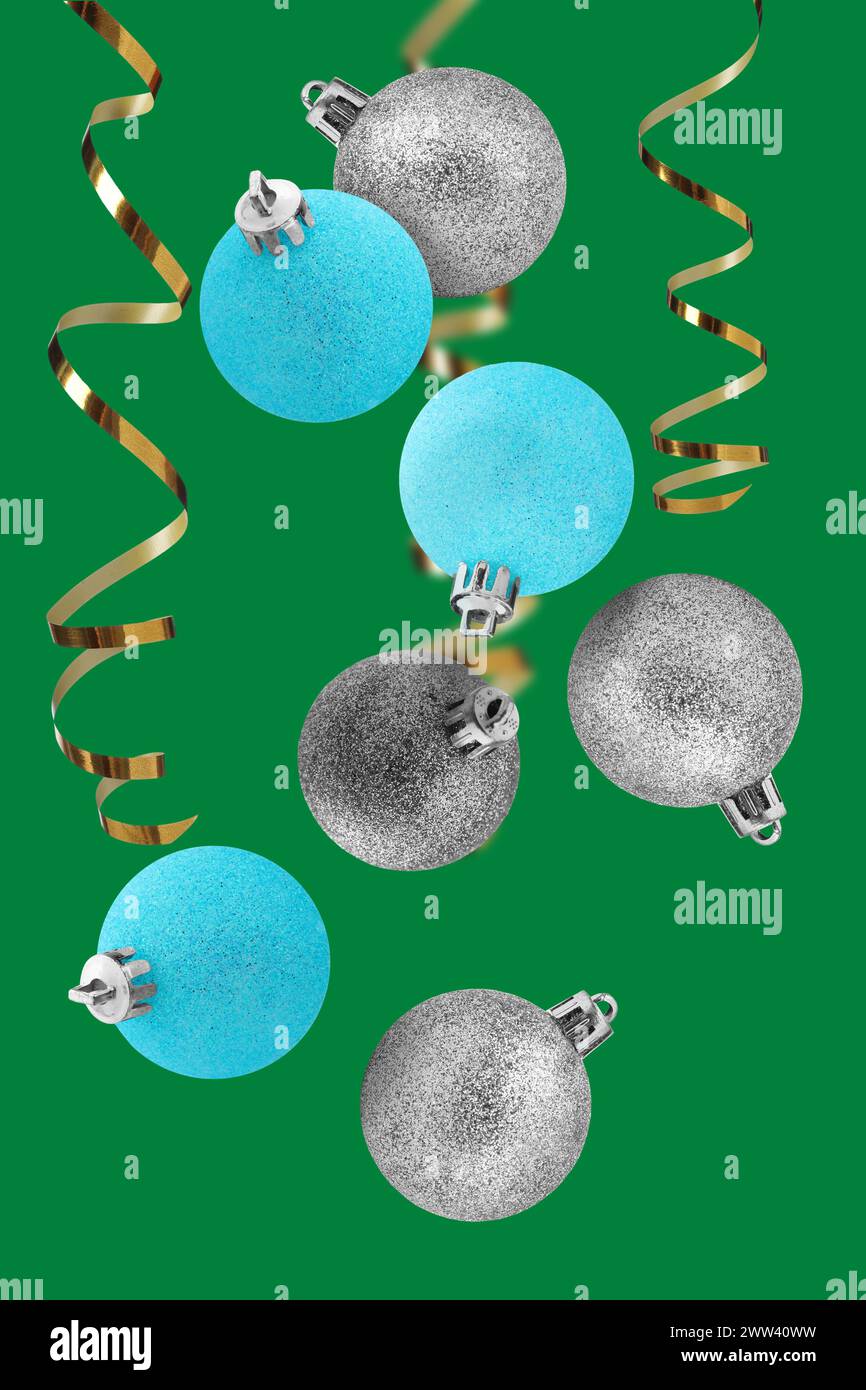 Different Christmas balls and serpentine streamers falling on green ...