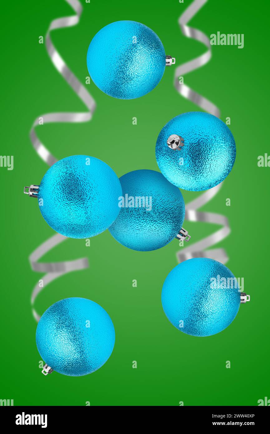 Light blue Christmas balls and serpentine streamers falling on green ...