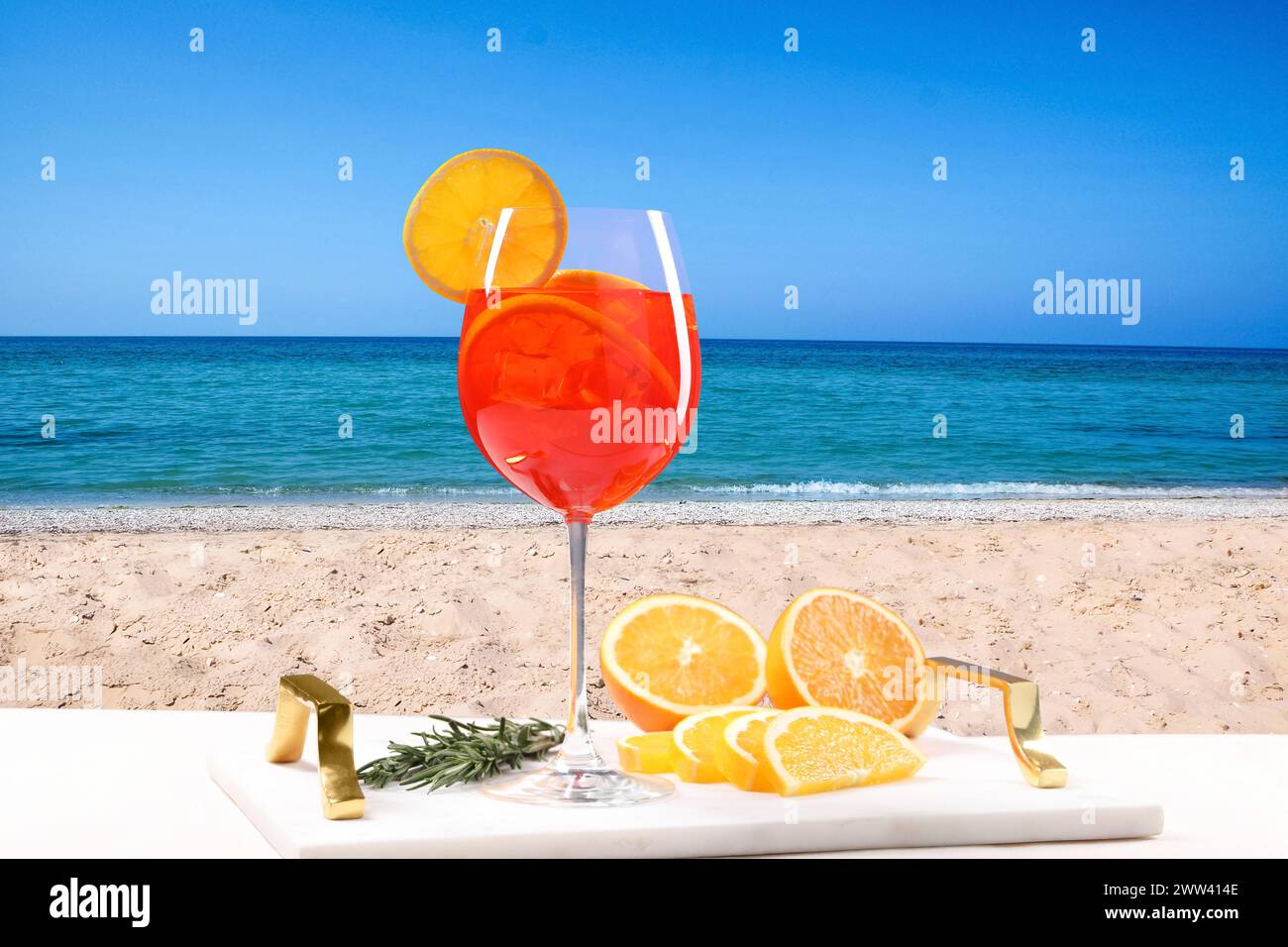 Aperol spritz cocktail in glass, orange slices and rosemary on table at ...