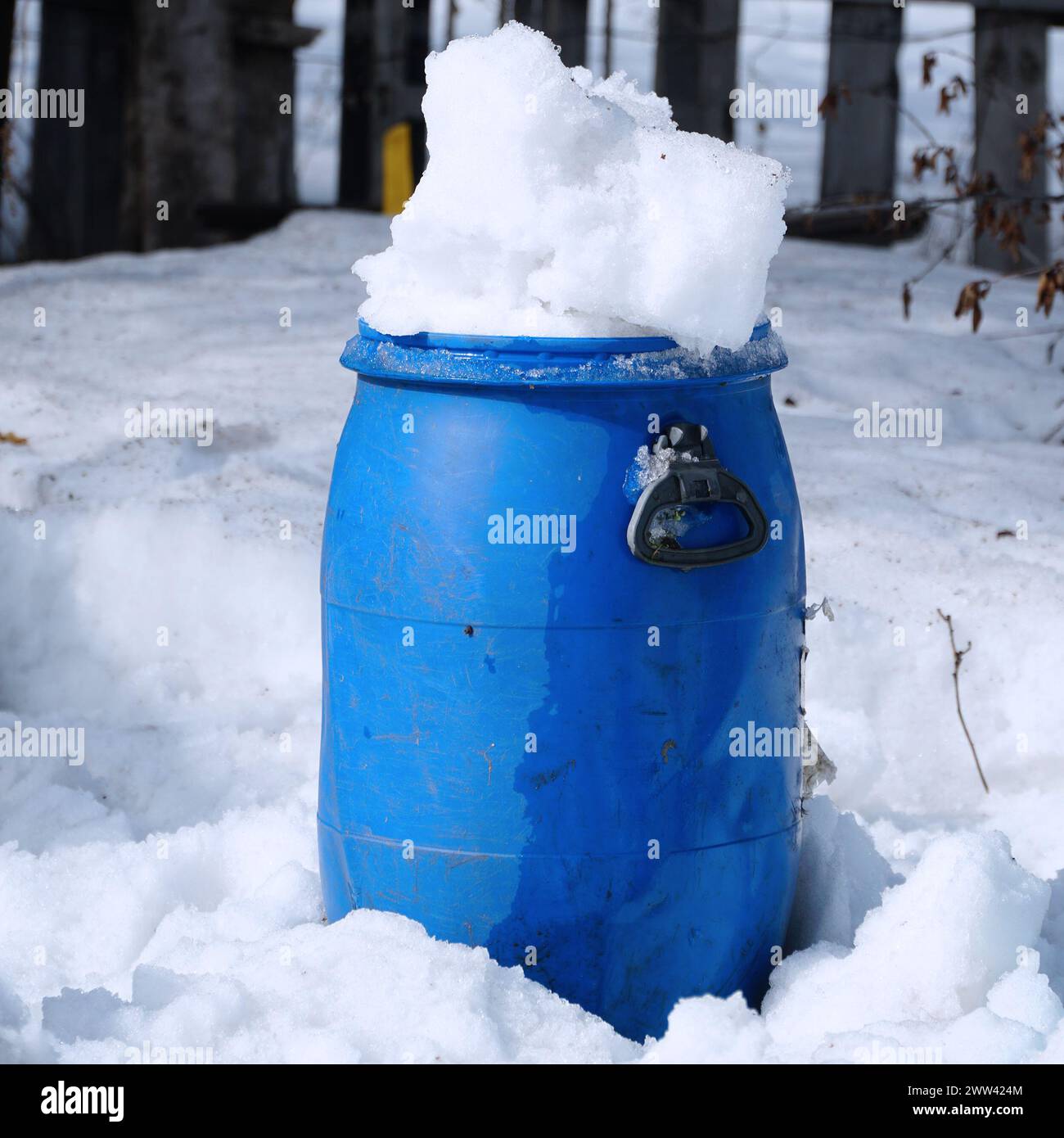 Melting spring snow in the garden in a barrel. Selective focus Stock ...