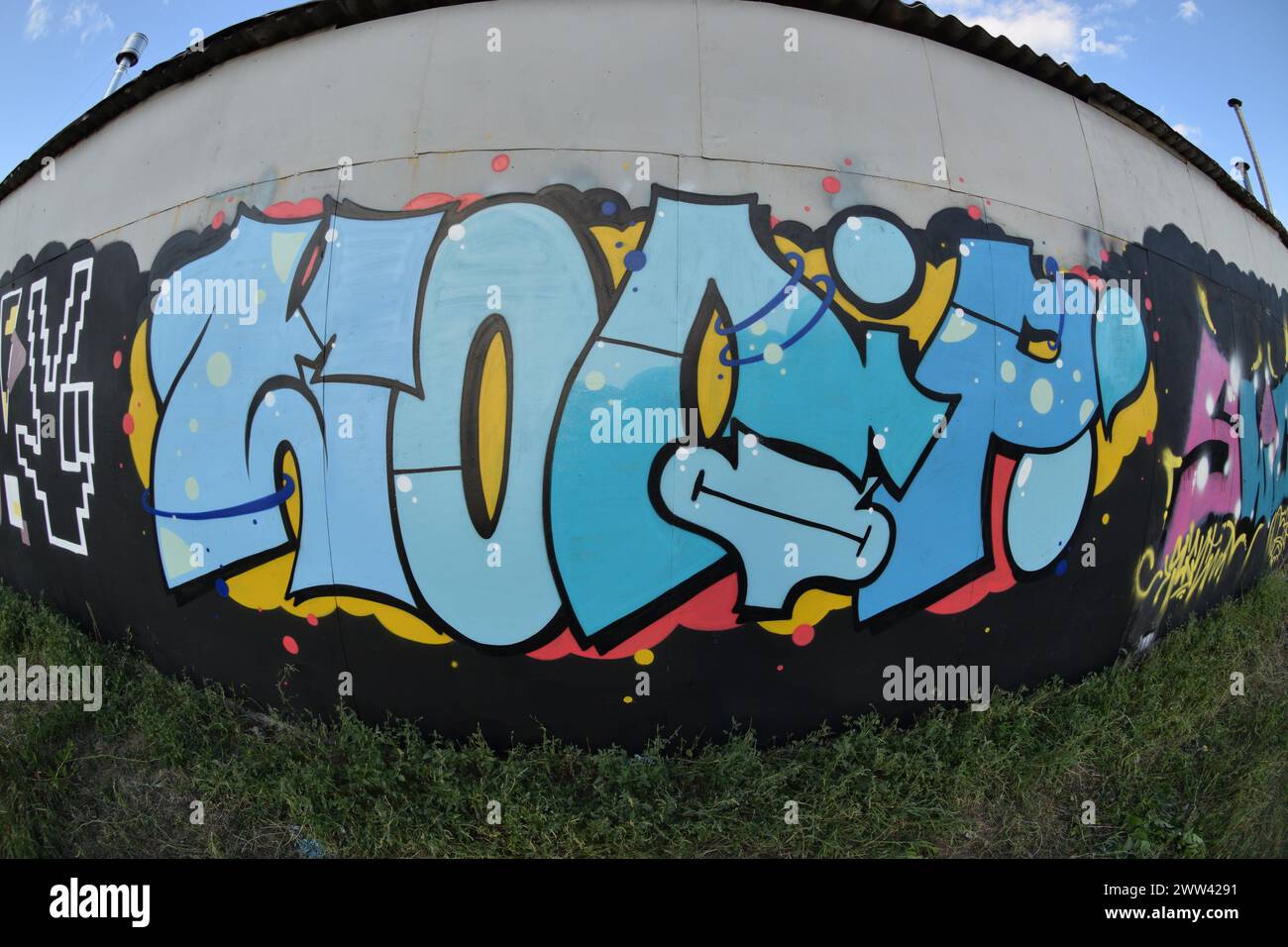 Fisheye shot of street art graffiti drawing on wall. Spray art artwork ...