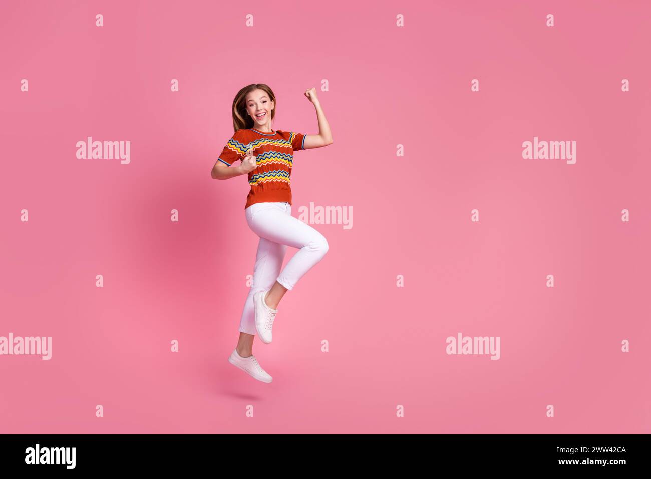 Full body photo of overjoyed cheerful person raise fists jump empty ...