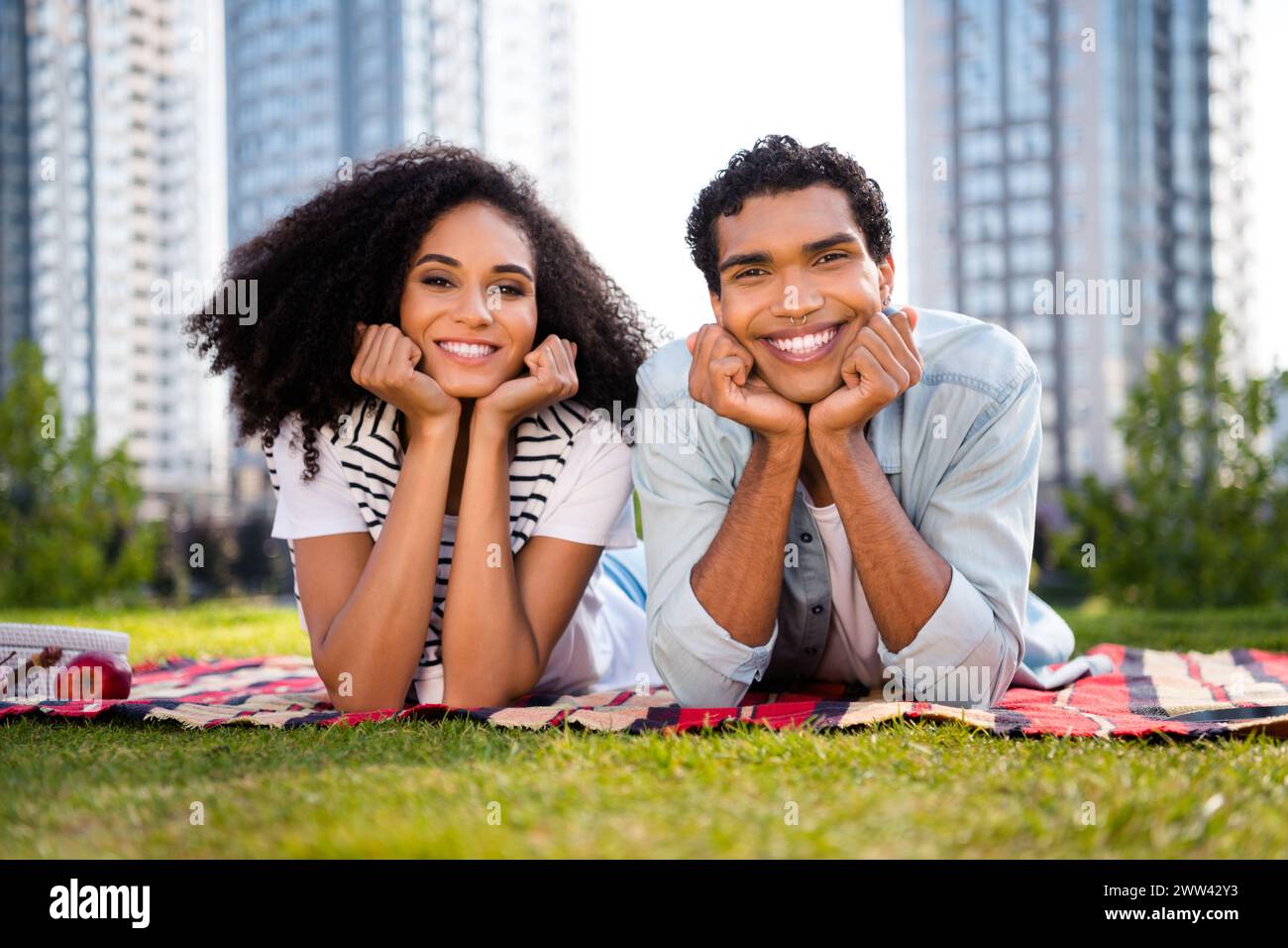 Photo of two positive nice people lying comfy blanket lawn toothy smile ...