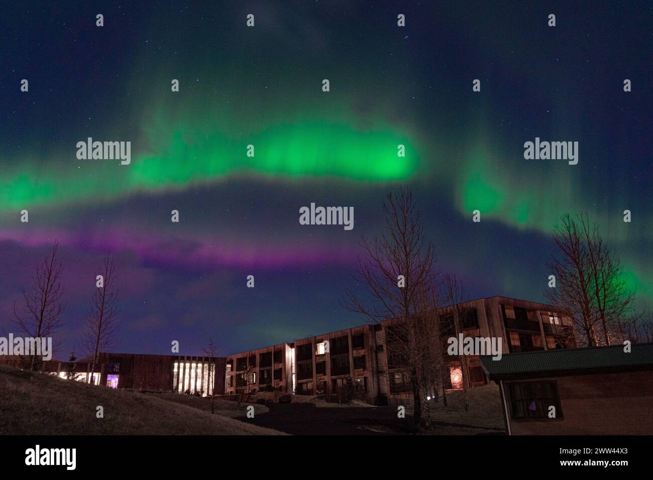 Some buildings illuminated by bright auroral northern lights Stock ...