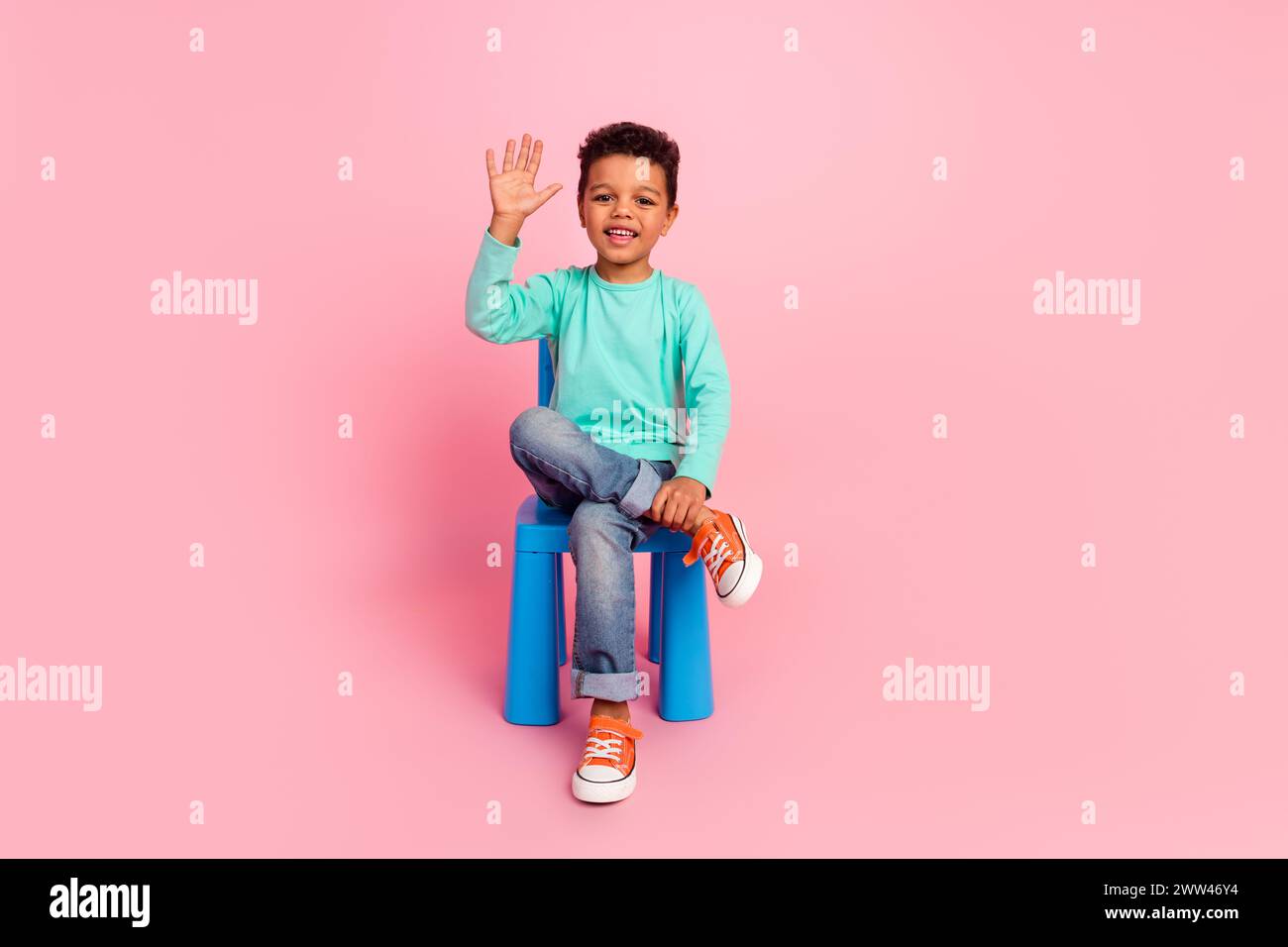 Full body photo of cute little boy sit chair wave hand say hello ...