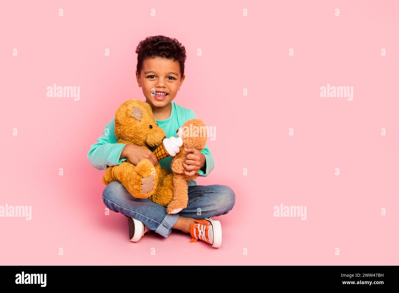 Full body photo of cute little boy sit floor play two teddy bears ...