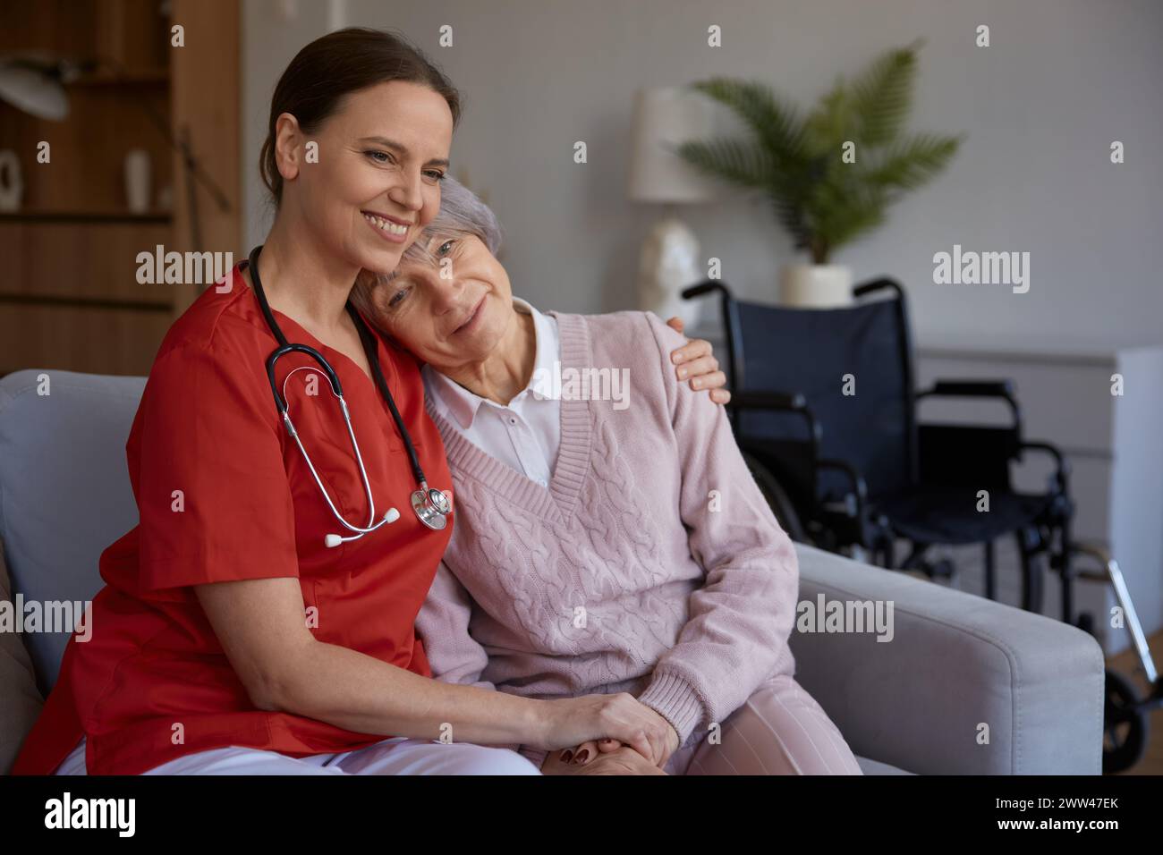 Smiling happily caregiver hugging her old lady patient portrait Stock ...
