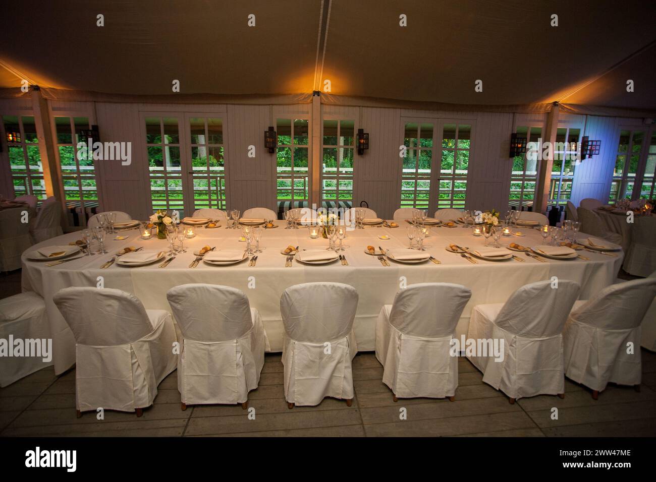 A sophisticated banquet hall, ready for guests, with tables dressed in ...
