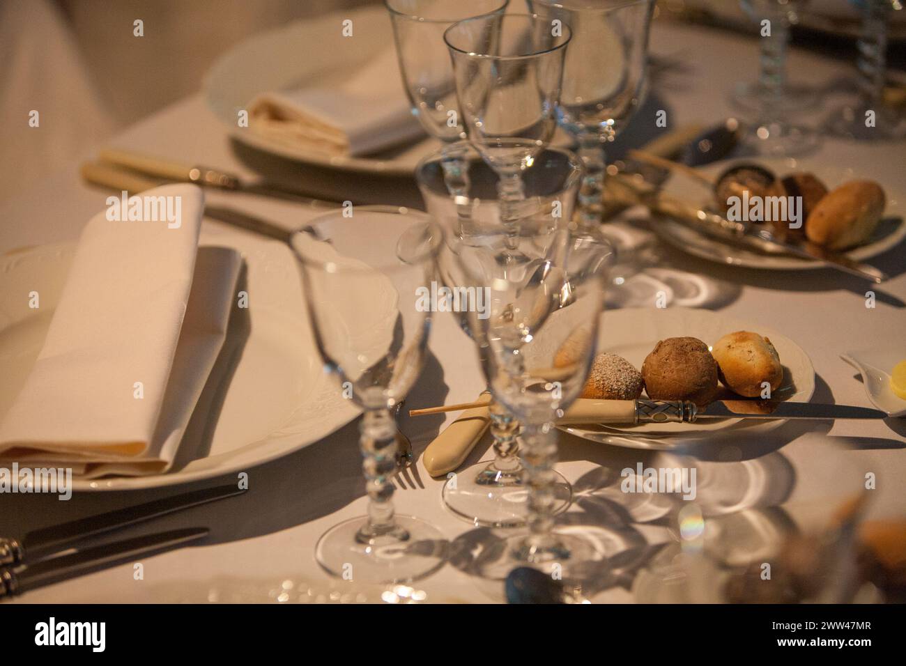 A close-up of a refined dining setup, featuring crystal clear glassware ...