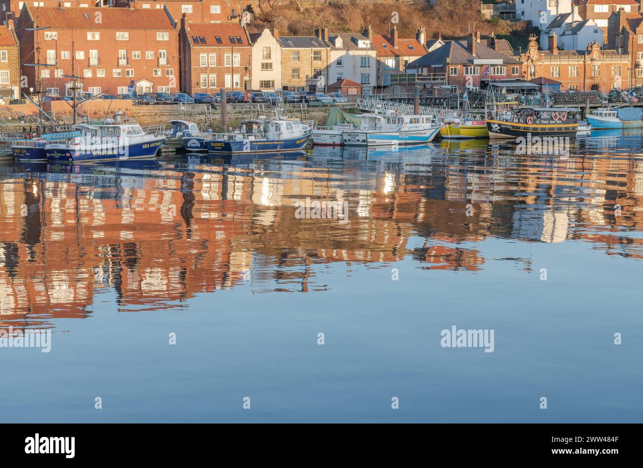 The Buildings on the East shore of the River Esk estuary reflected in ...