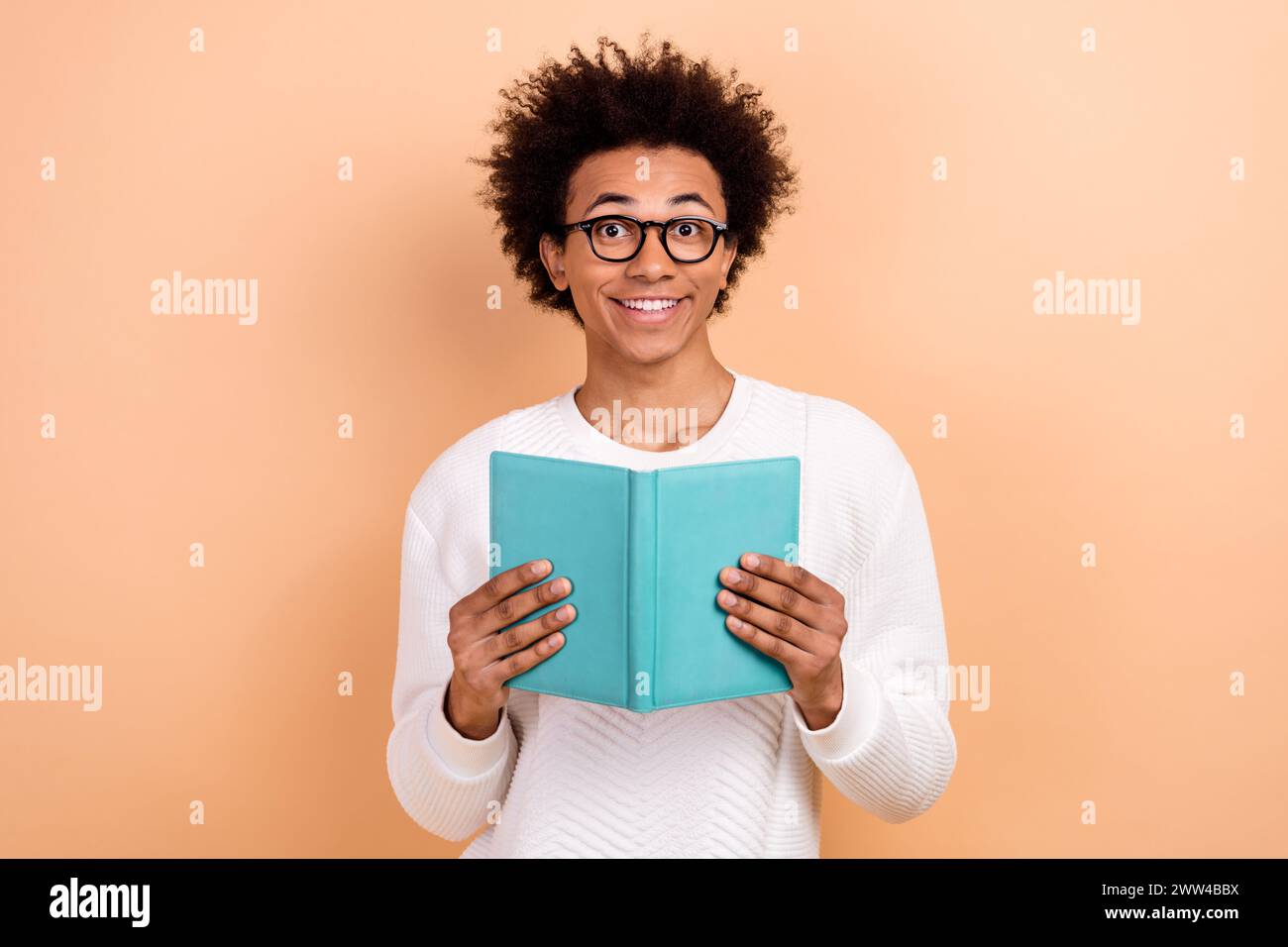 Photo of cheerful smart man wear trendy white clothes hold encyclopedia ...