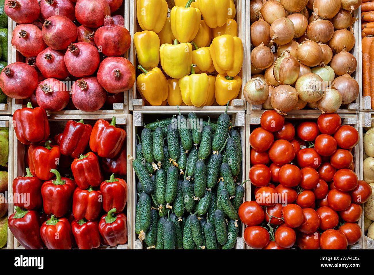 A counter with different vegetables in drawers is beautifully and ...