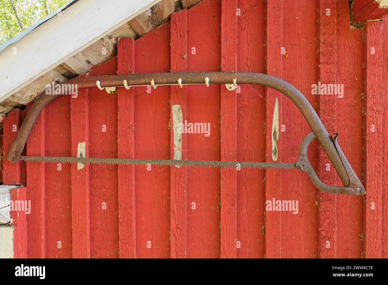 Closeup of old rusty bow saw (swede saw, finn saw or bucksaw) hanging ...