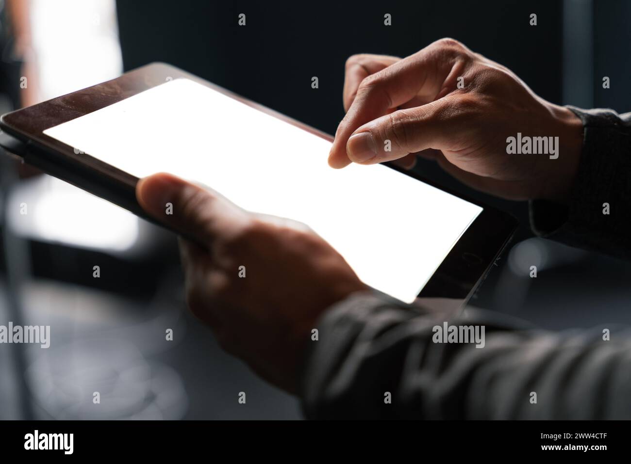Person using tablet with white screen and hand gestures Stock Photo - Alamy