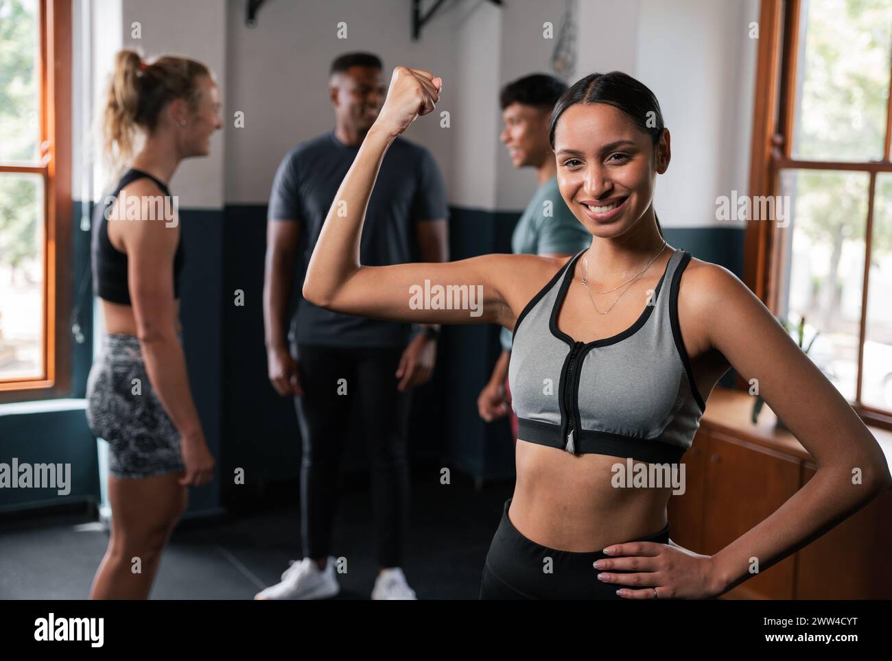 Woman flexing muscles confidently hi-res stock photography and images ...
