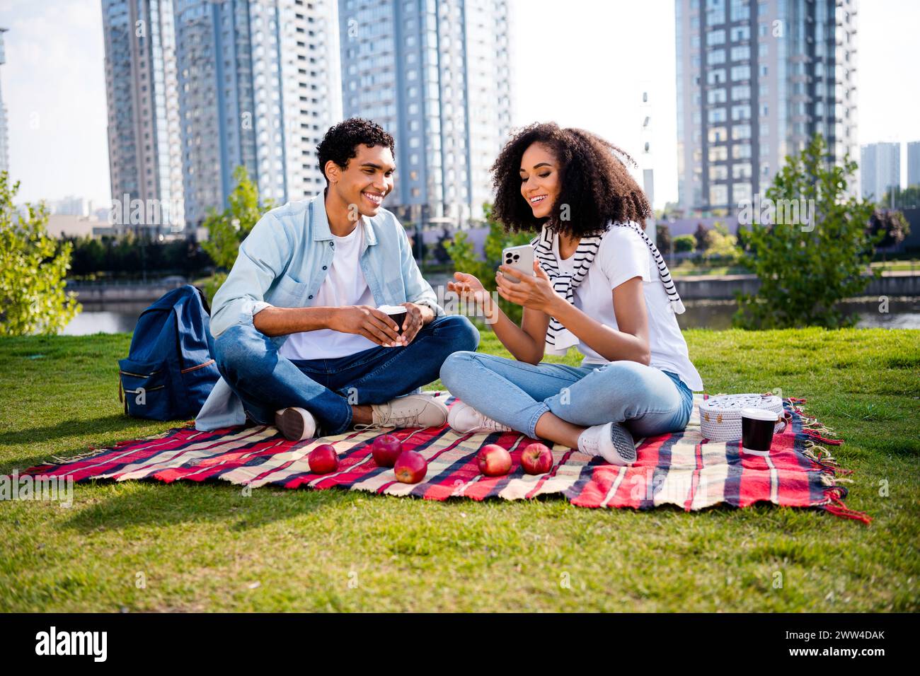 Full body photo of two beautiful people sit blanket drink coffee use ...