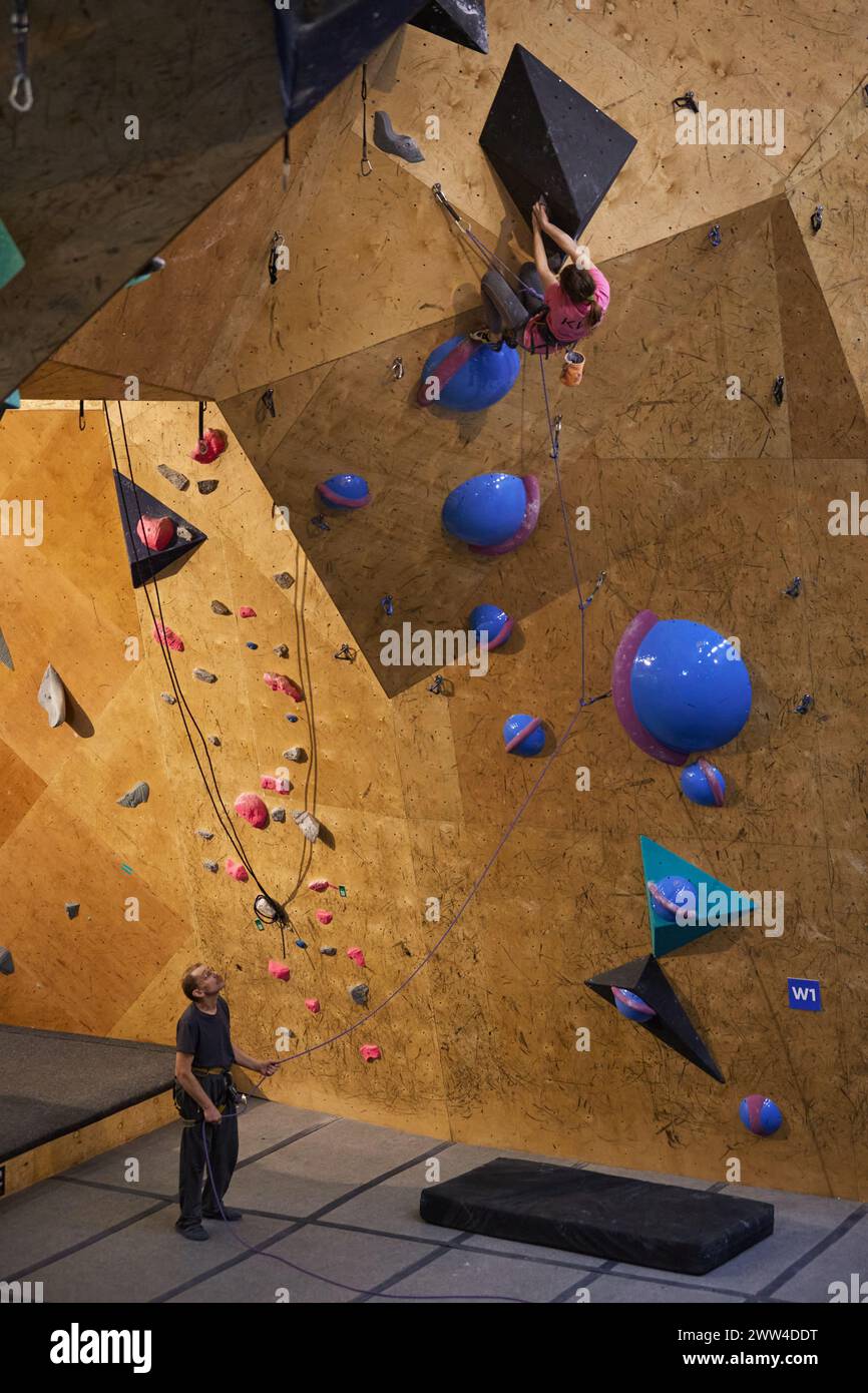 Ukrainian climber hanging on a big height in a climbing gym. Kyiv - 10 ...