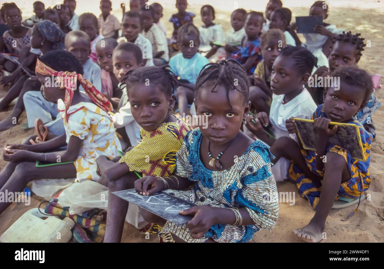 Niger, Niamey, children learn to write outside their primary school ...