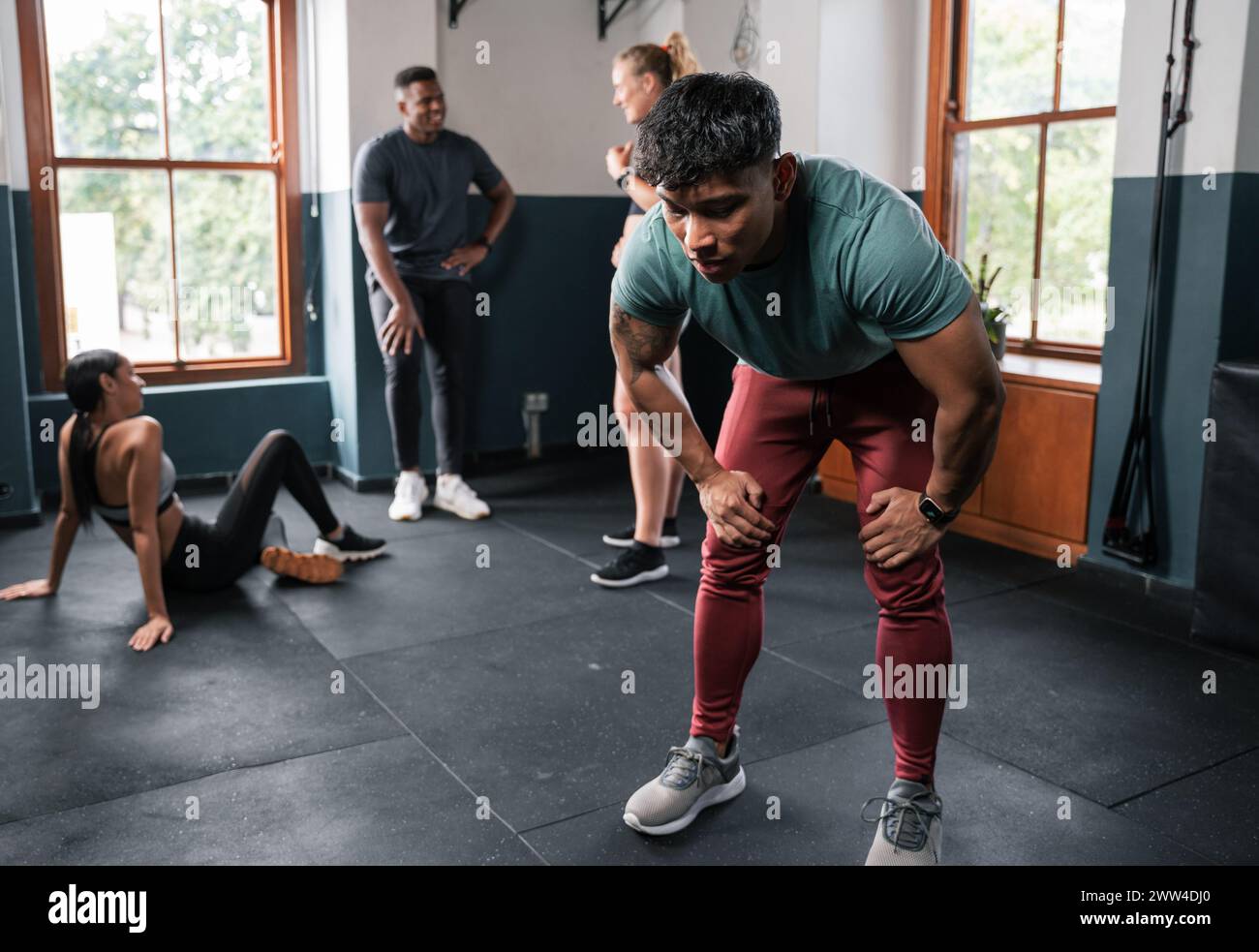 People in gym doing arm and leg exercises, wearing shorts Stock Photo ...