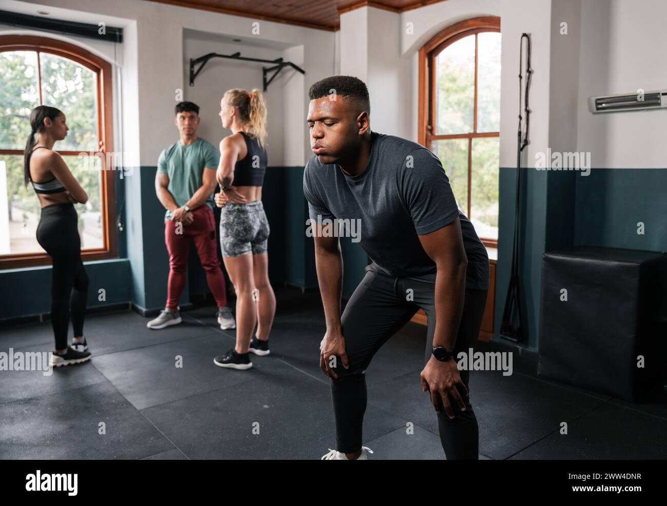 People exercising in gym, working on joints, arms, legs, muscles thighs ...