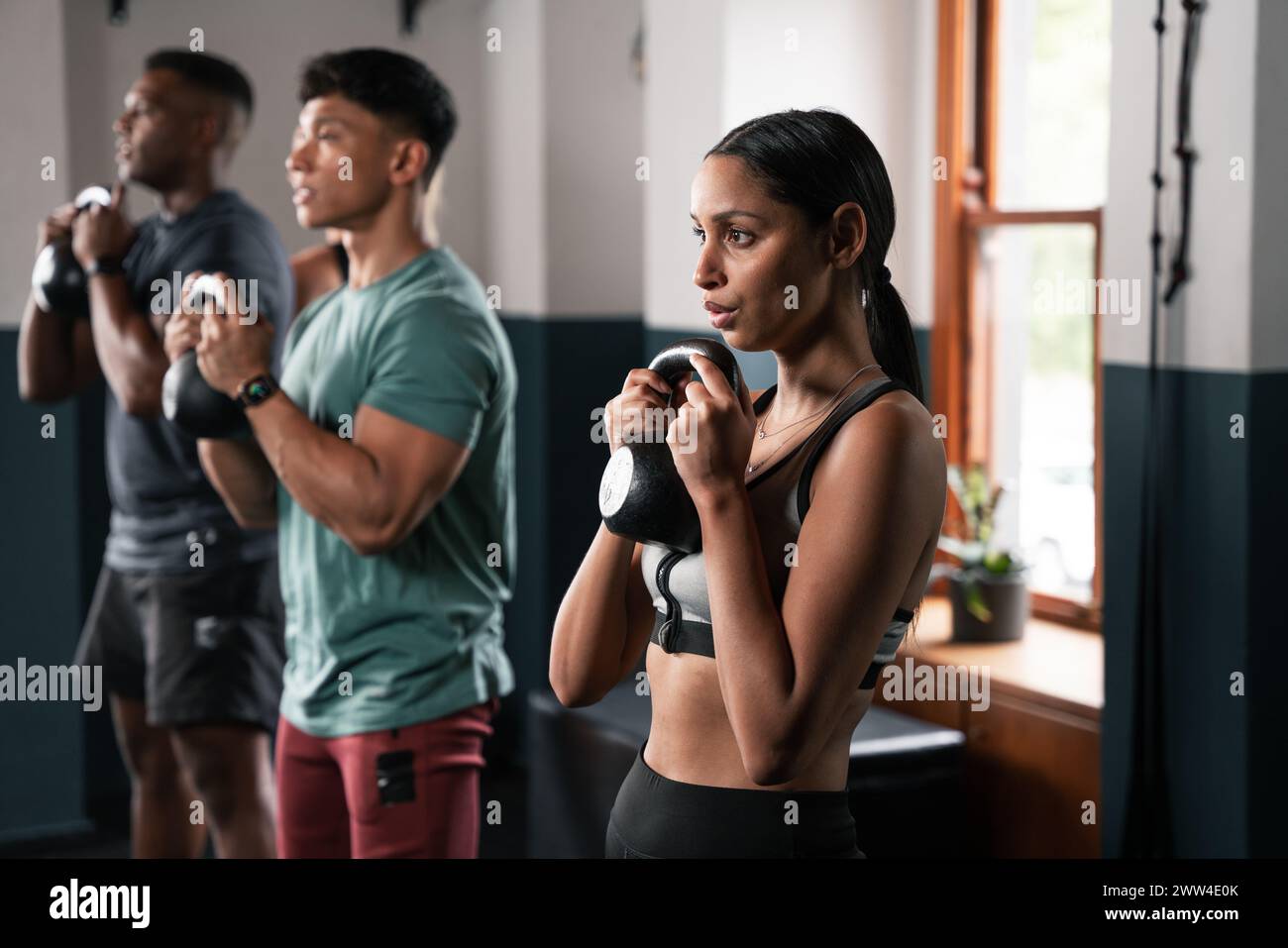 People in gym doing kettlebell exercises for arm muscles Stock Photo ...