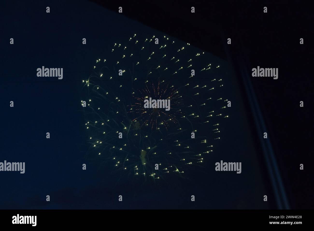 Ball-shaped large fireworks in the night sky photographed from the ...