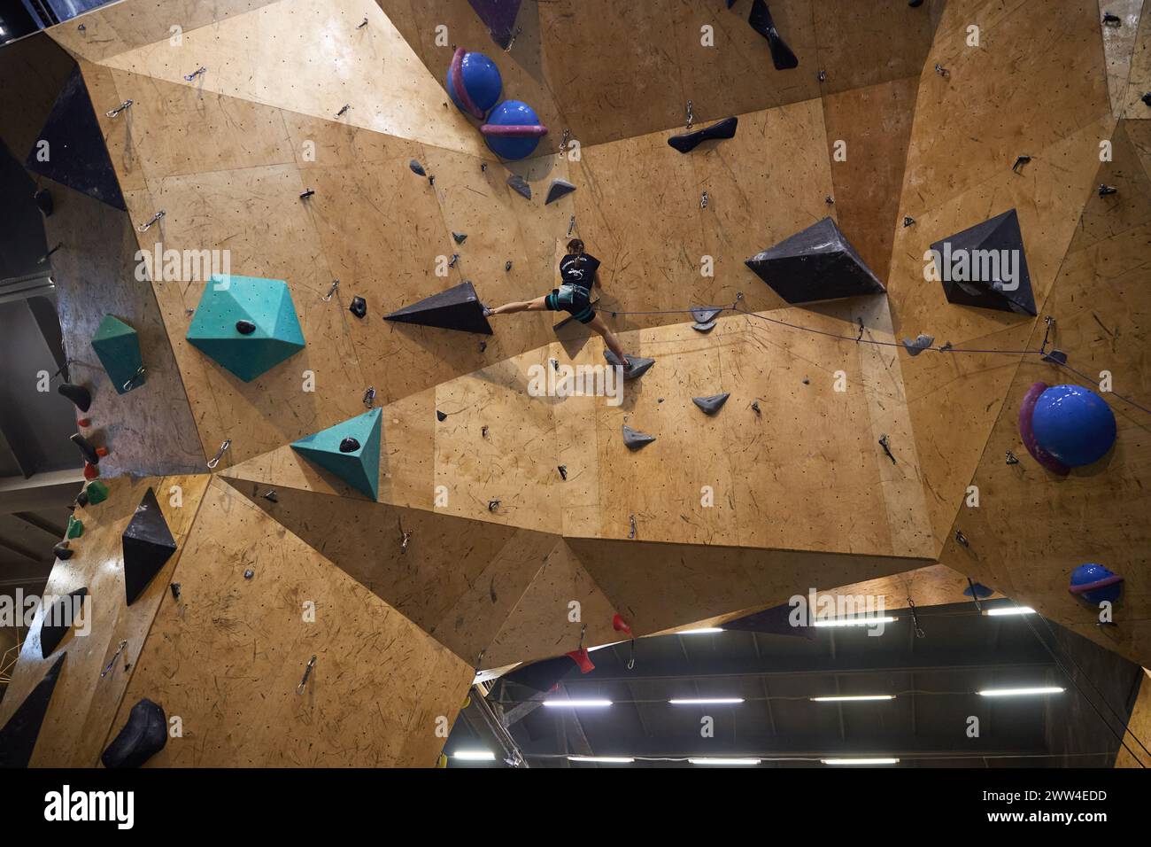 Climber on a climbing wall photographed from below on a All-Ukrainian ...