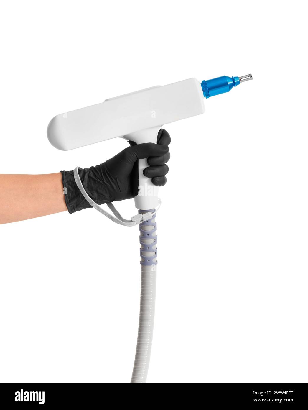 The hand of a cosmetologist holds a laser handpiece with a nozzle for ...