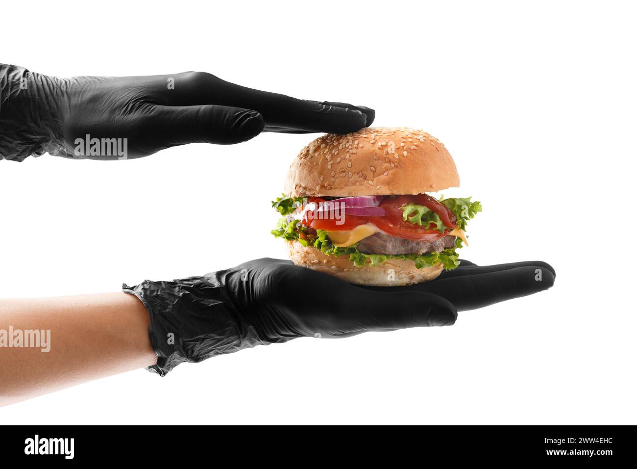 Hands in black gloves hold a juicy, appetizing beef burger on a white ...