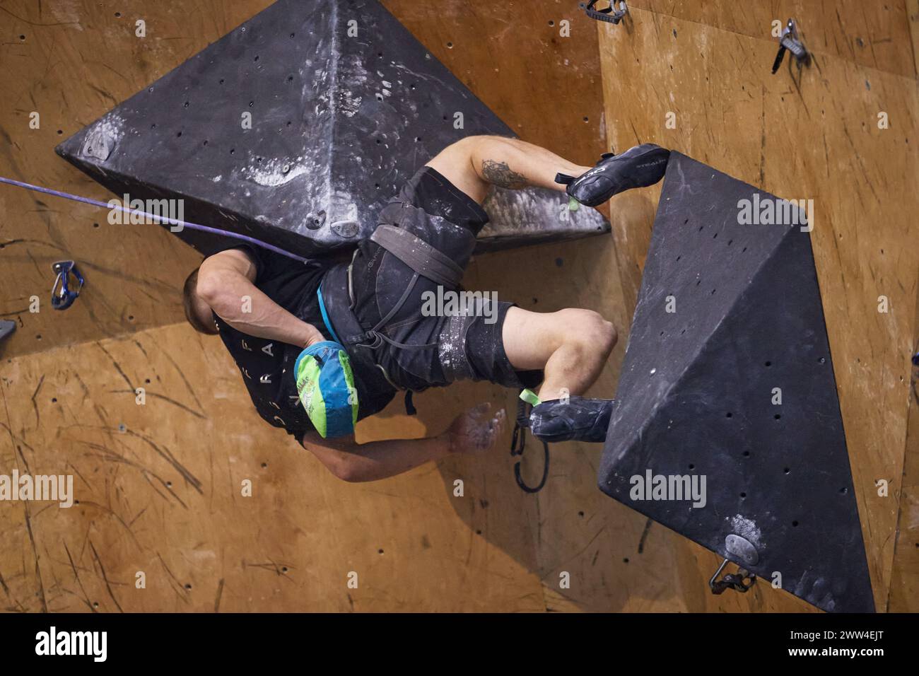 Professional climber using climbing chalk (magnesium powder) while ...