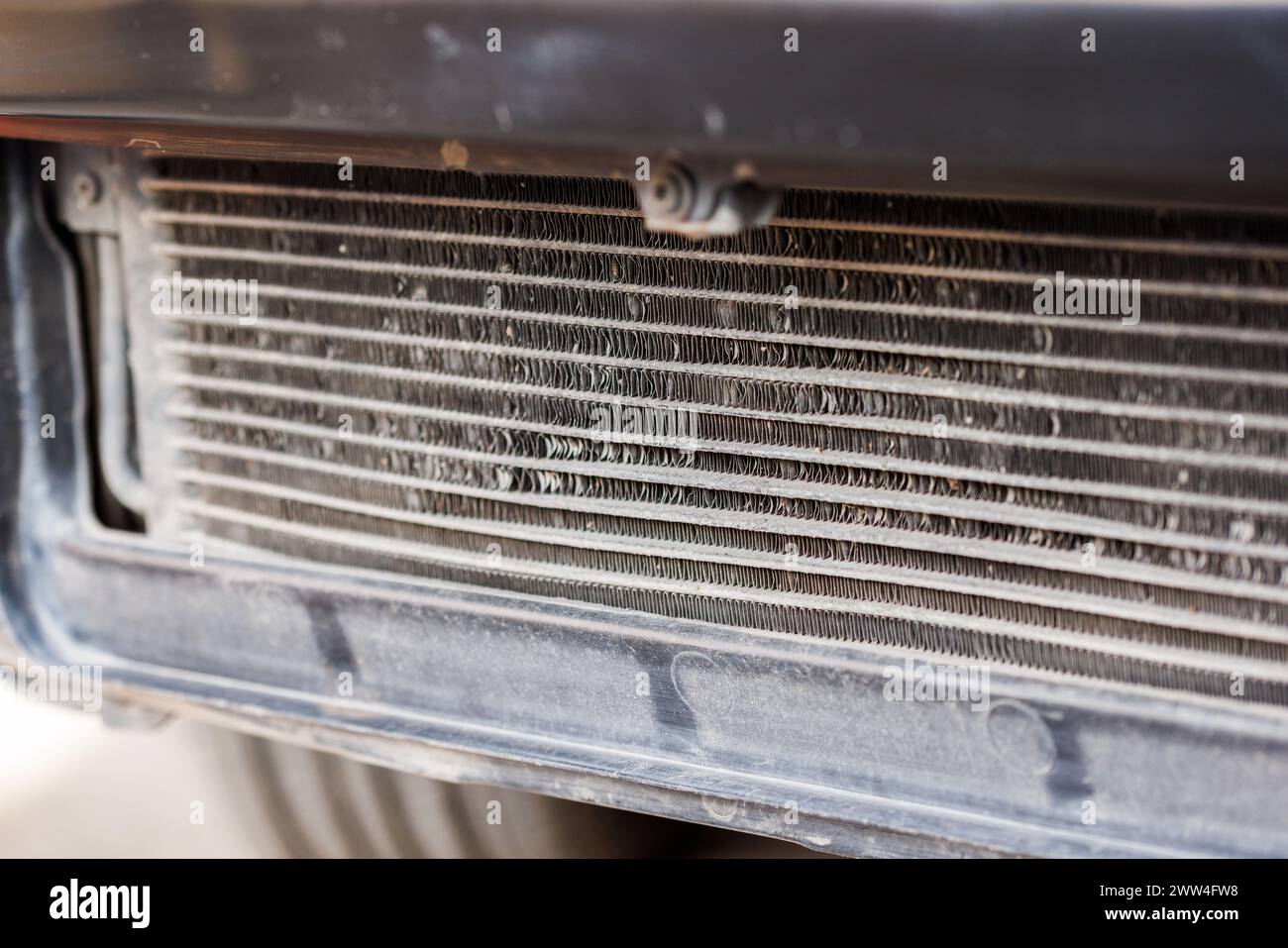 beaten but alive car AC radiator with rock hit traces Stock Photo - Alamy