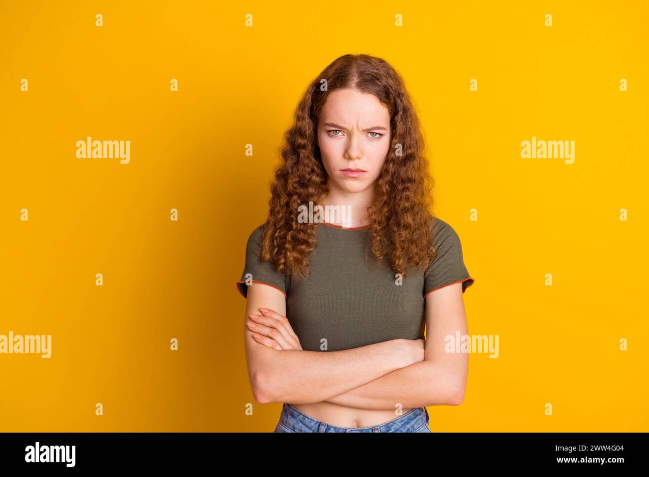 Photo of serious angry unsatisfied woman standing with crossed hands ...