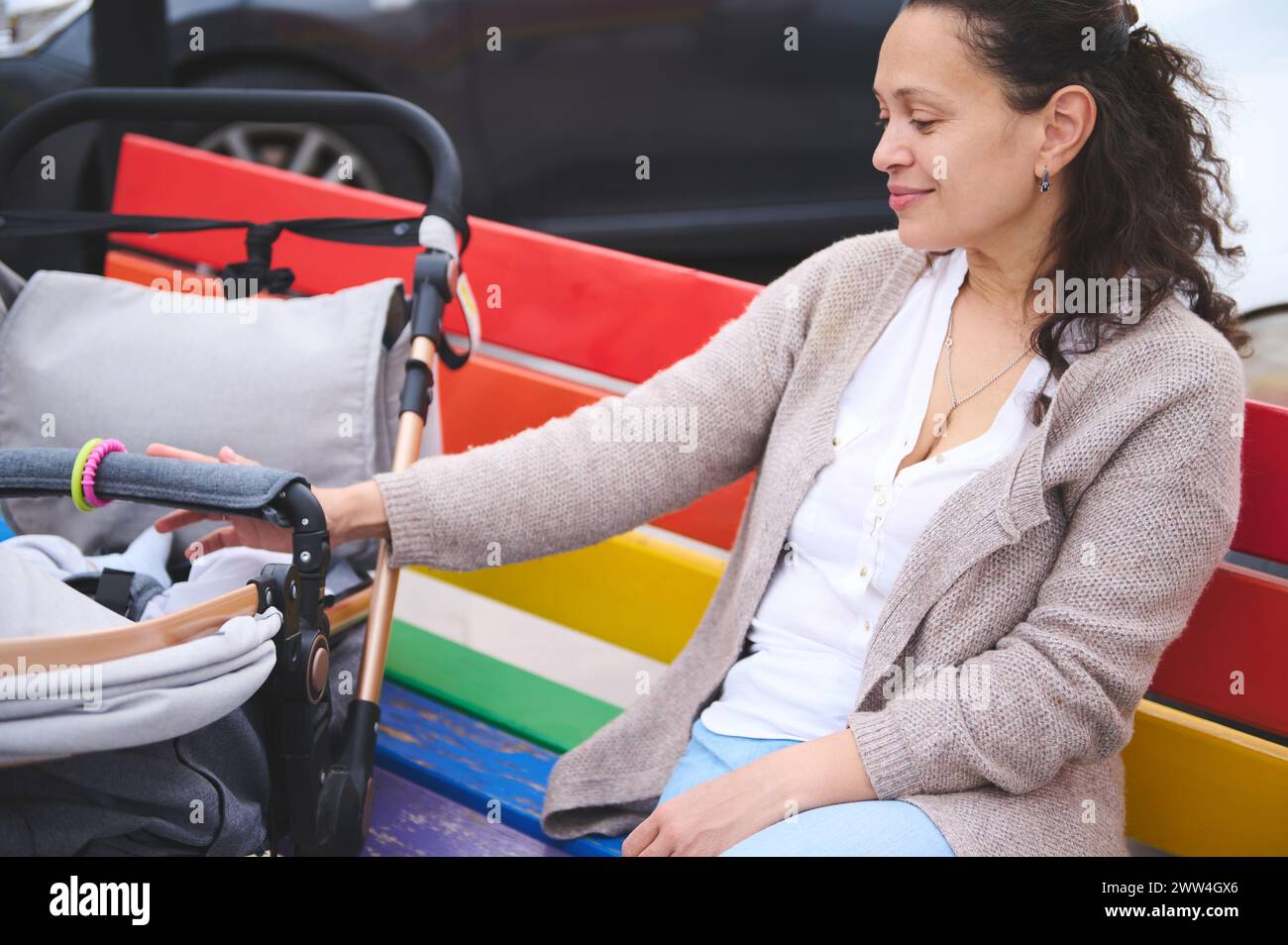 Authentic pretty woman, mother smiling while pushing a baby pram with ...