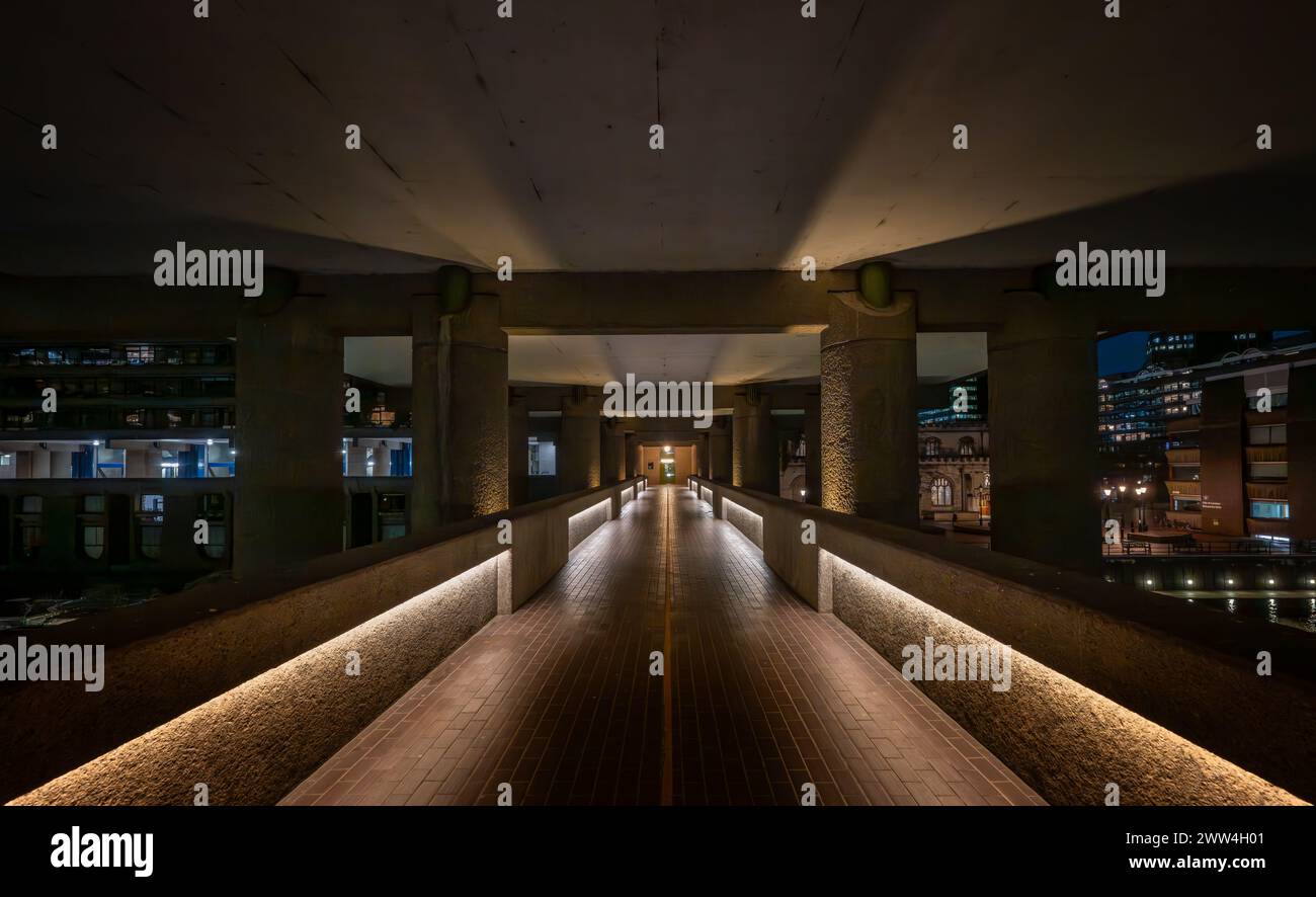 London, UK: Deserted high-level walkway at night on the Barbican Estate ...