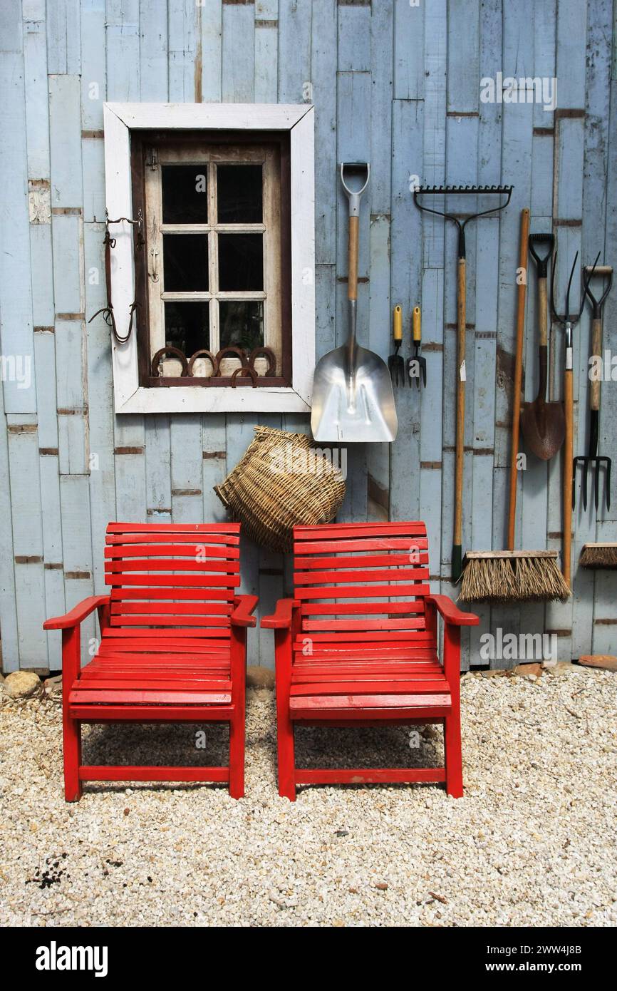 Double red chair and farmer's farming equipment background Stock Photo ...