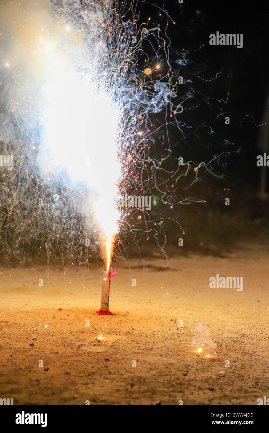 The small fountain of lit firecrackers releasing colored ignited ...