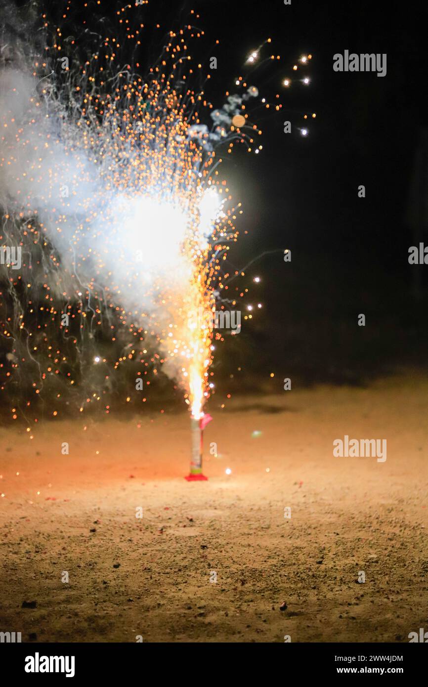 The small fountain of lit firecrackers releasing colored ignited ...