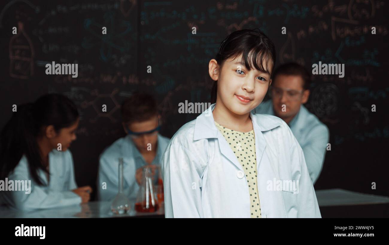 Cute asian scientist smile to camera while diverse group doing ...