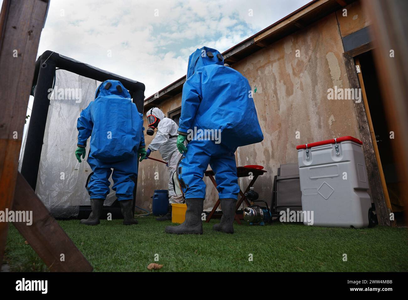 People wear Personal protective equipment (PPE) with gas mask for ...