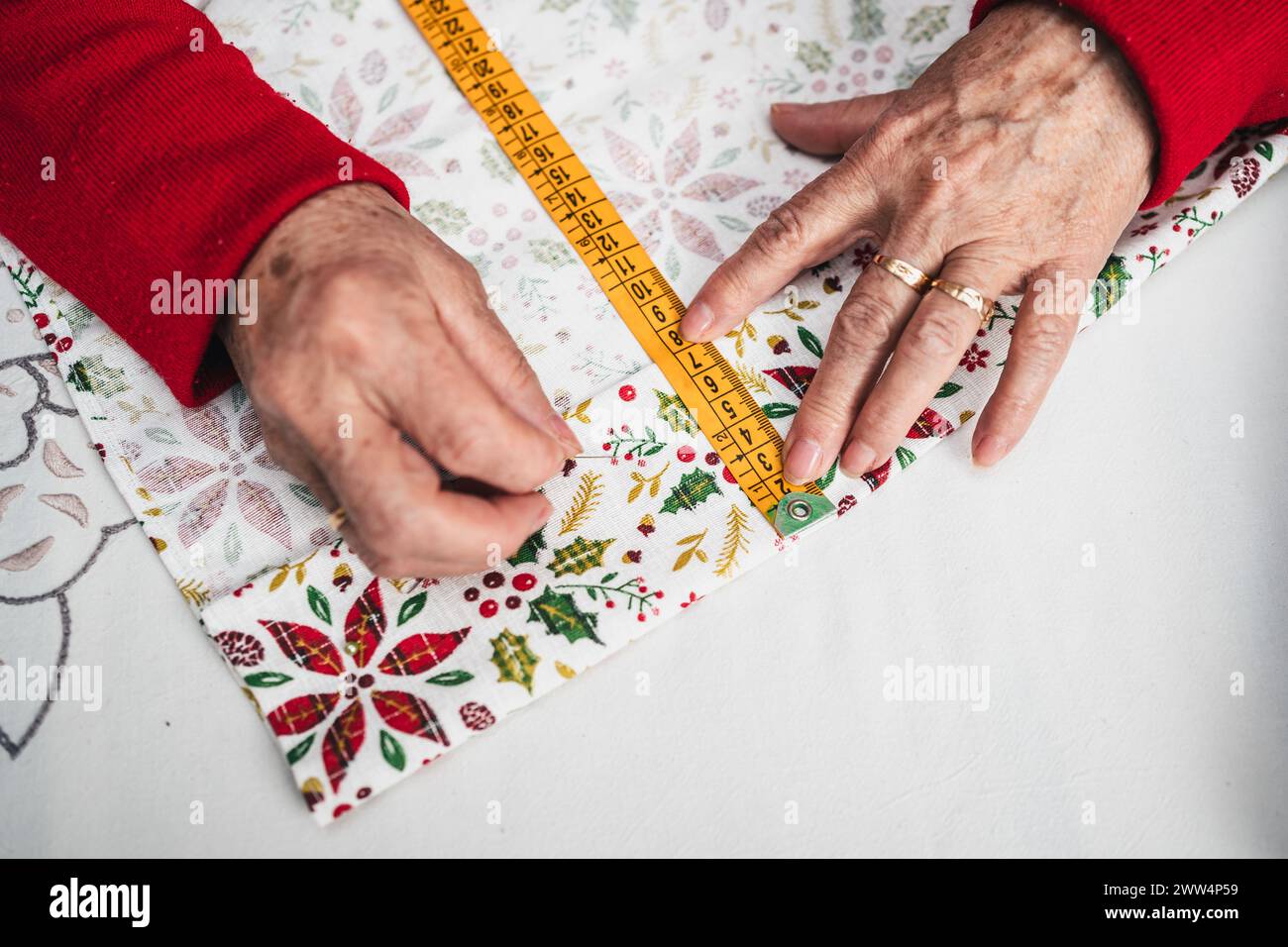 senior woman hands measuring with sewing meter to prepare work on ...