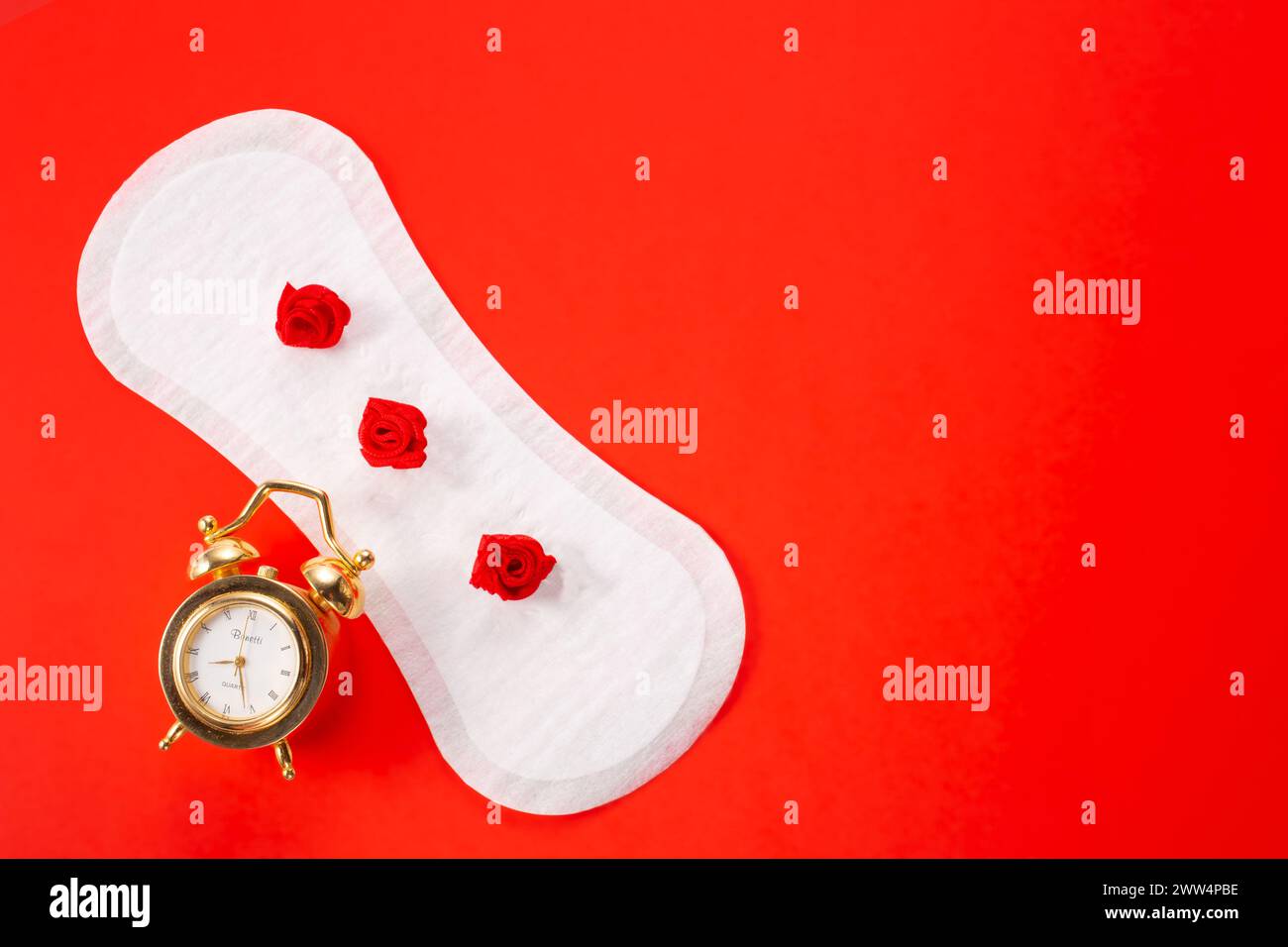 Blood, alarm clock and feminine hygiene pad with red flowers on red ...