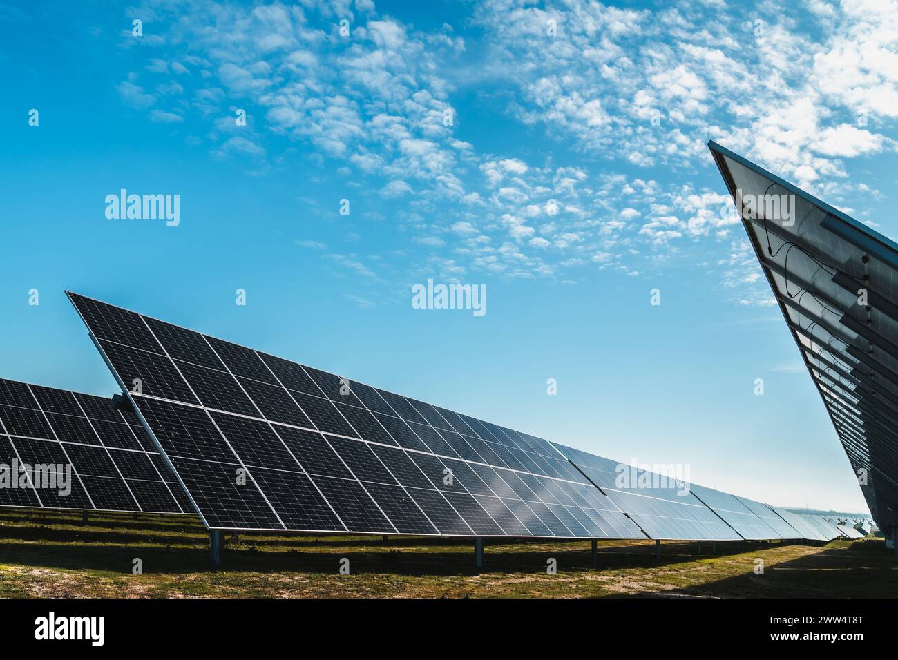 line of solar panels in photovoltaic solar plant, bright sunny day ...