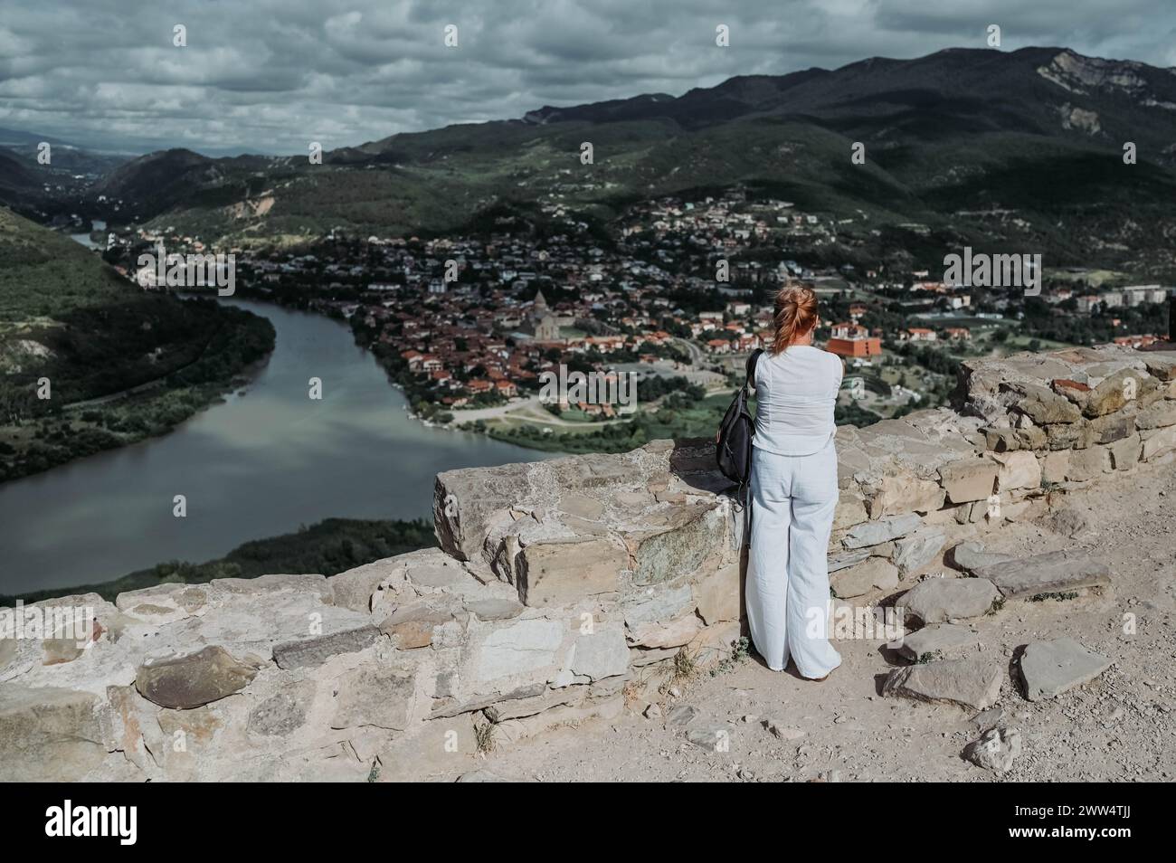 Mature woman tourist takes pictures on observation deck confluence of ...