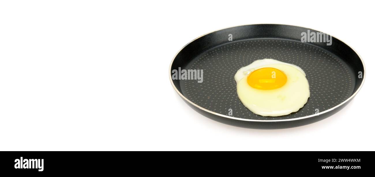 Fried egg in cast iron frying pan sprinkled isolated on white from ...