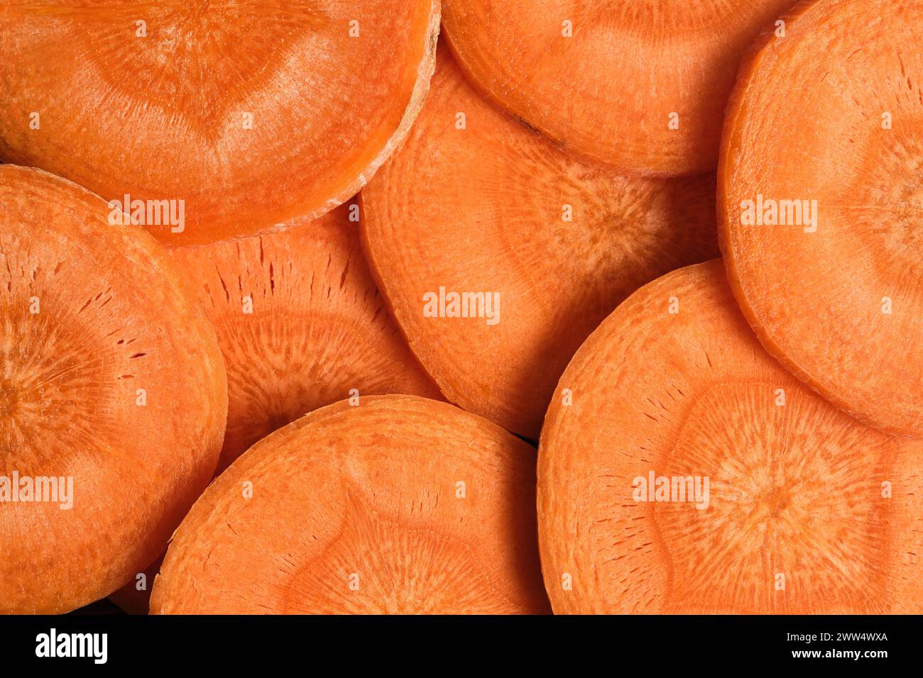 Background carrot sliced into rings closeup Stock Photo - Alamy