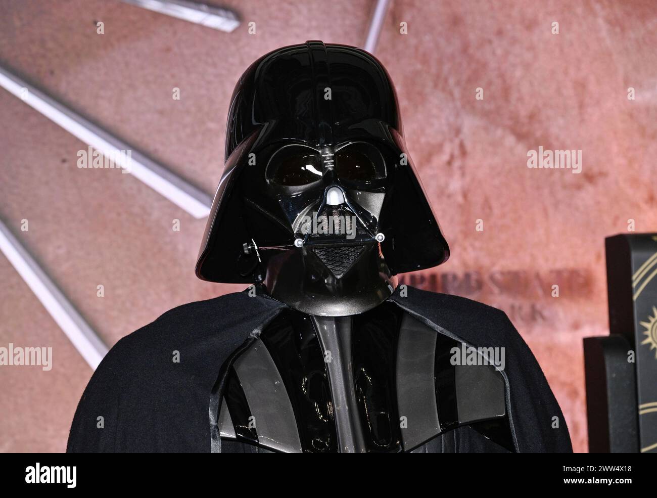 A Darth Vader costumed character participates in the Star Wars themed ...