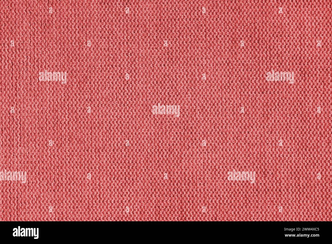 Textile background, red coarse fabric texture, cloth structure close up ...
