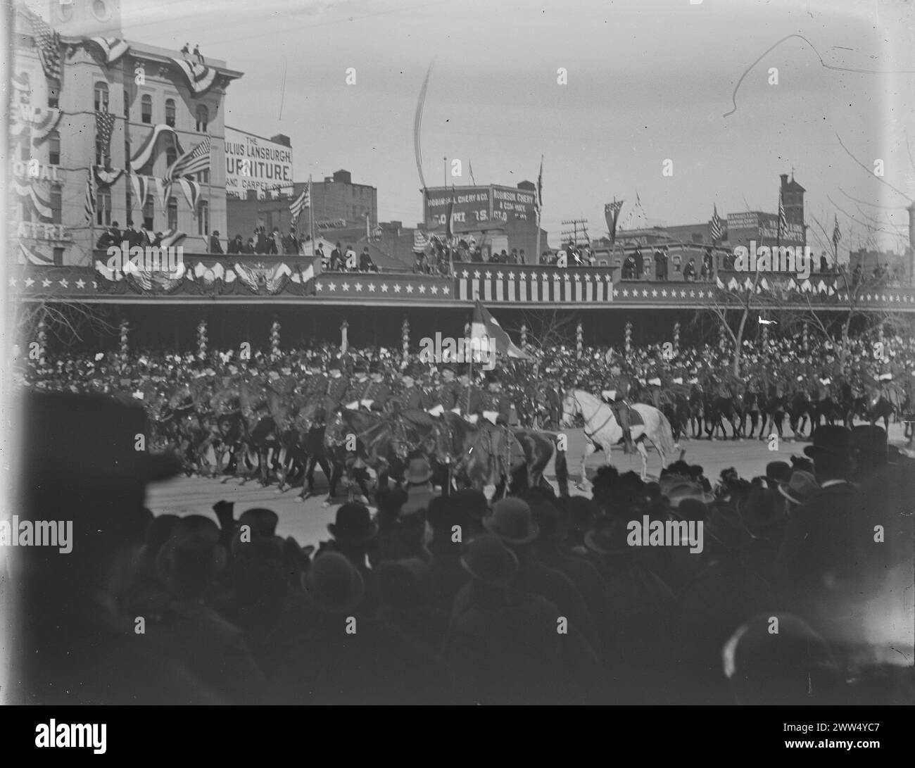 Two lines of soldiers, separated by a soldier riding a white horse ...