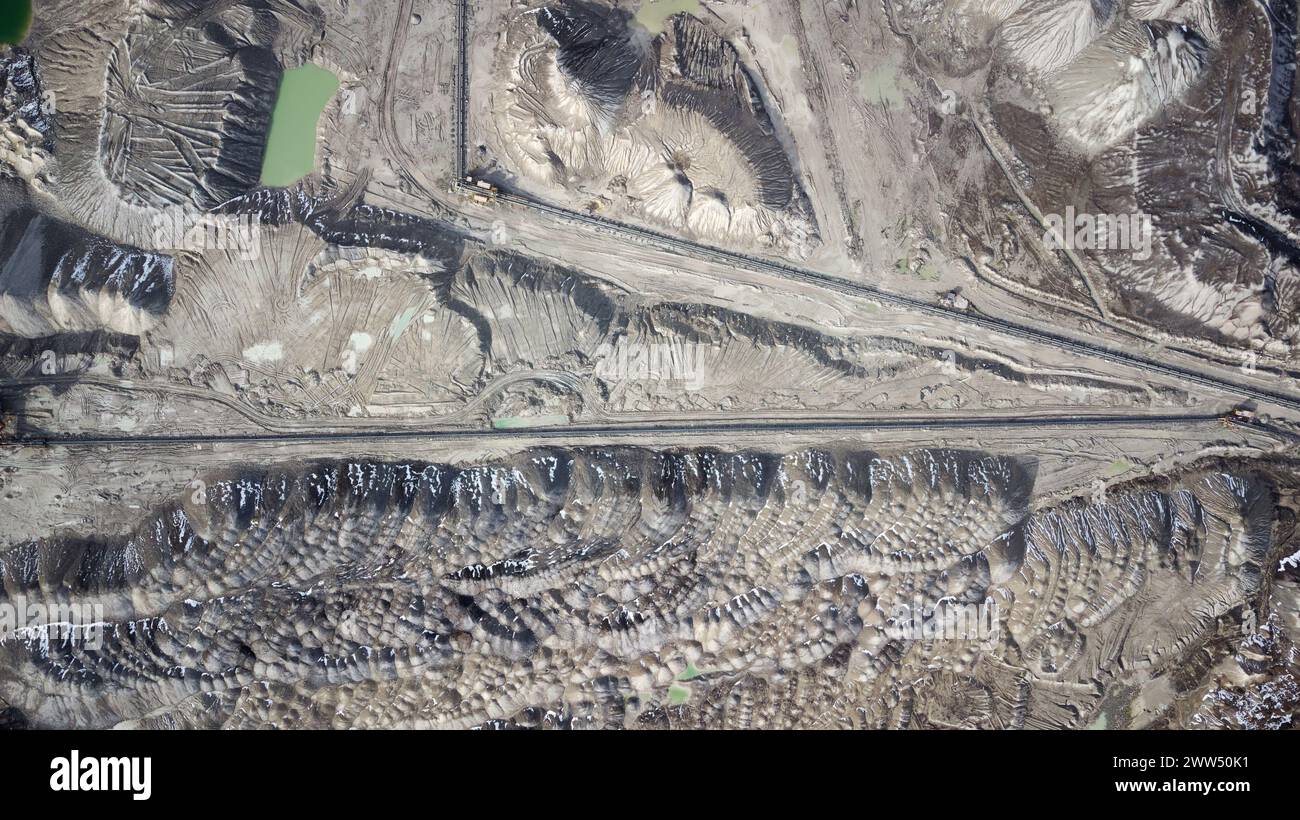 Aerial view of open mine pit. Drone shot of coal mining activity. Water ...
