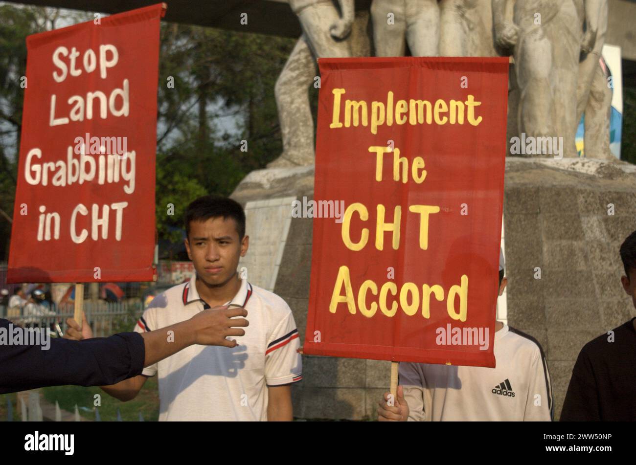 Dhaka, Bangladesh. 22nd Mar, 2024. Indigenous activists hold banners that read ''Stop Land ...
